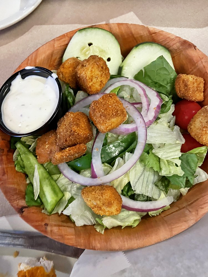 A fresh garden salad topped with crispy croutons brings a lighter option to the seafood feast.