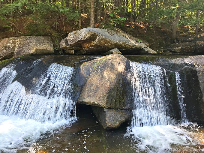 Water splits perfectly around the center rock, creating a symmetrical display that would make any architect jealous.