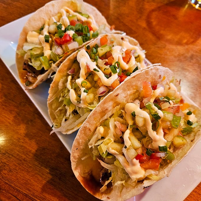 Fish tacos done right: crisp lettuce, fresh salsa, and a drizzle of creamy sauce that ties it all together perfectly. Photo credit: Hans Deffner