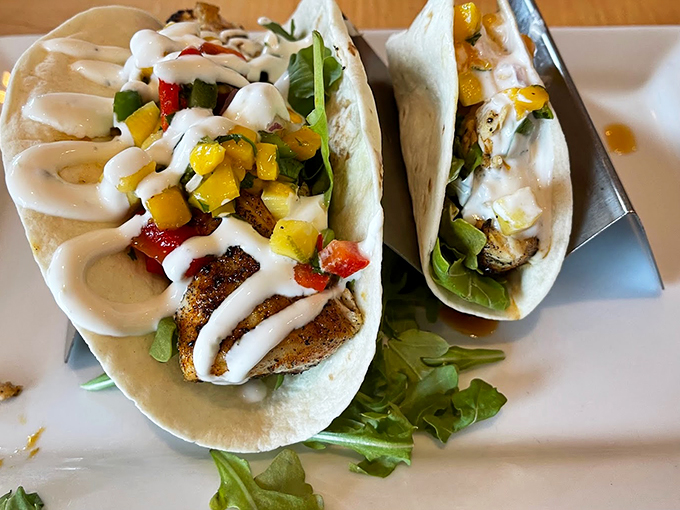 Fish tacos that bring a taste of coastal fusion to Maine, dressed in bright mango salsa and creamy sauce. Photo credit: T