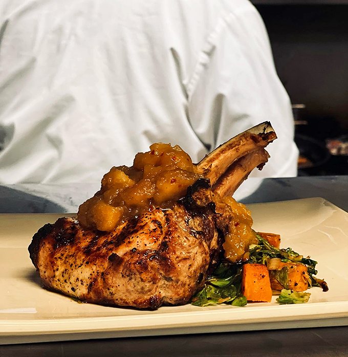 Holy chop, Batman! This tomahawk pork chop is so impressive, it deserves its own theme music.