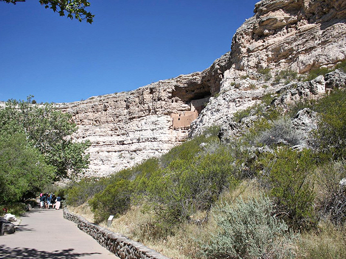 Ancient cliff dwellings peek through the foliage, playing hide-and-seek with modern-day explorers.