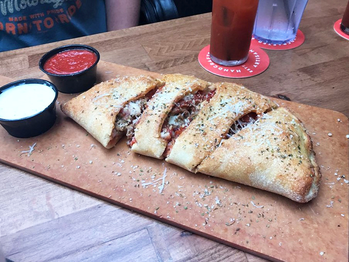 Meet the calzone: pizza's mysterious, folded cousin. It's like a steamy, cheesy love letter sealed with a crispy, golden kiss.