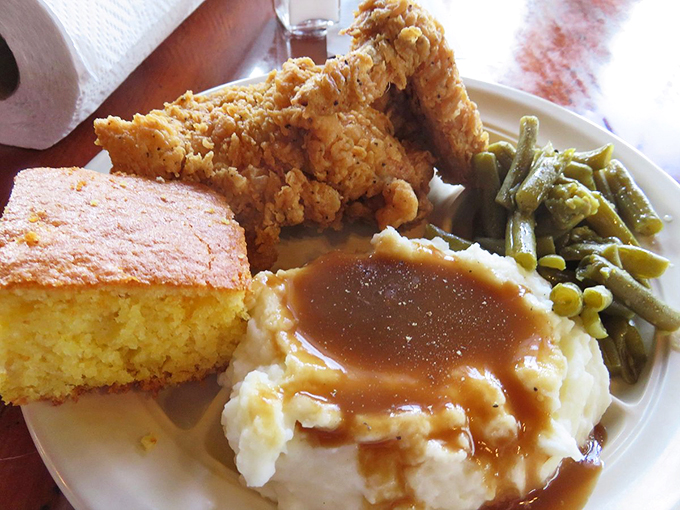 The holy trinity of Southern comfort: crispy chicken, creamy mashed potatoes, and golden cornbread. It's like a hug for your taste buds!