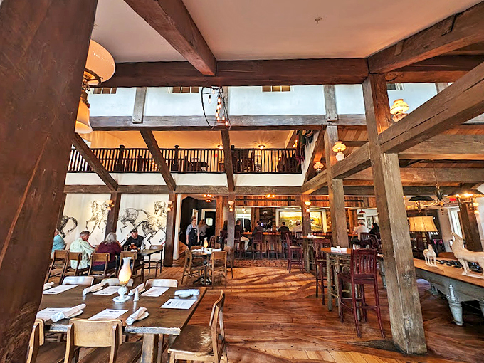 Rustic charm meets modern comfort! The White Horse Inn's interior, with its soaring beams and warm lighting, invites you to sit and stay awhile. 