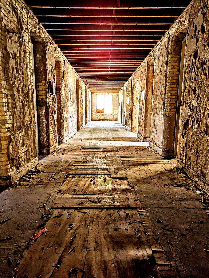 Eerie echoes of the past: This haunting hallway at Traverse City State Hospital whispers tales of bygone days. Photo credit: Eva Moore