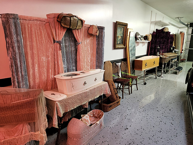Step into a time capsule of final farewells! Pink velvet and vintage caskets create an oddly charming atmosphere that's more fascinating than frightening.