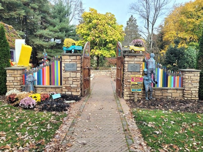 Whimsy takes root! A rainbow-fenced wonderland where giant pencils and toy cars sprout alongside flowers.