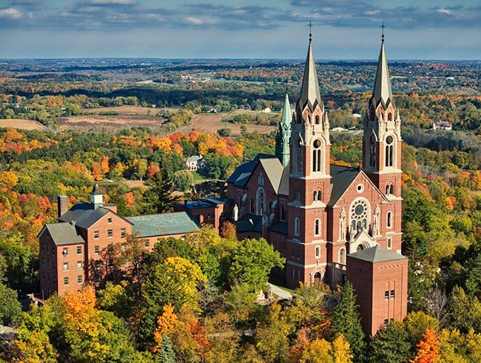 Heavenly views and earthly delights! This architectural marvel stands tall amidst a sea of autumn colors, like a divine dessert on nature's platter.