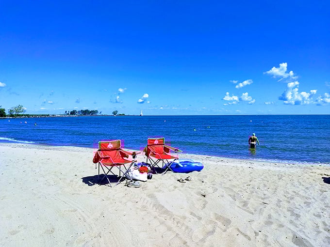 Sun-kissed paradise or Ohio secret? Red chairs beckon like old friends, inviting you to soak up Lake Erie's charm. Photo credit: Sue Hendricks