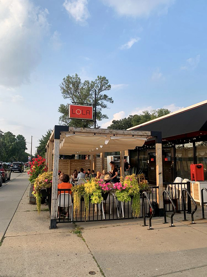 Pizzeria Lola: Alfresco dining never looked so inviting! This patio is like a pizza lover's secret garden, minus the talking rabbits.