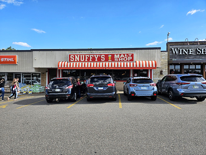 Welcome to shake paradise! Snuffy's striped awning beckons like a portal to the 1950s, promising malts that could make Elvis swivel his hips.