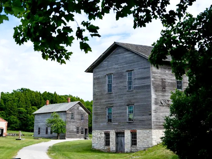 Nature's slow dance with abandoned industry. Fayette's weathered buildings whisper tales of a bustling past. Photo credit: Great Lakes Explorer