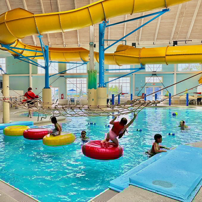 Splashes, laughter, and a little friendly chaos &ndash; kids challenge the floating course, dodging wobbling rings and towering water slides above. Photo credit: Blue Harbor Resort & Conference Center