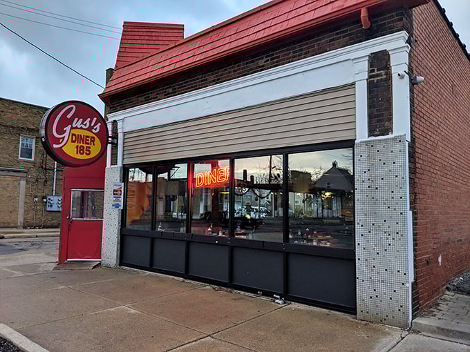 Step into Gus's, where the neon sign promises comfort and the aroma of home fries seals the deal.