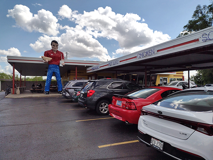 Gus's Drive-In: Where classic cars meet classic eats. This retro paradise is busier than a phone booth during the Superman era.