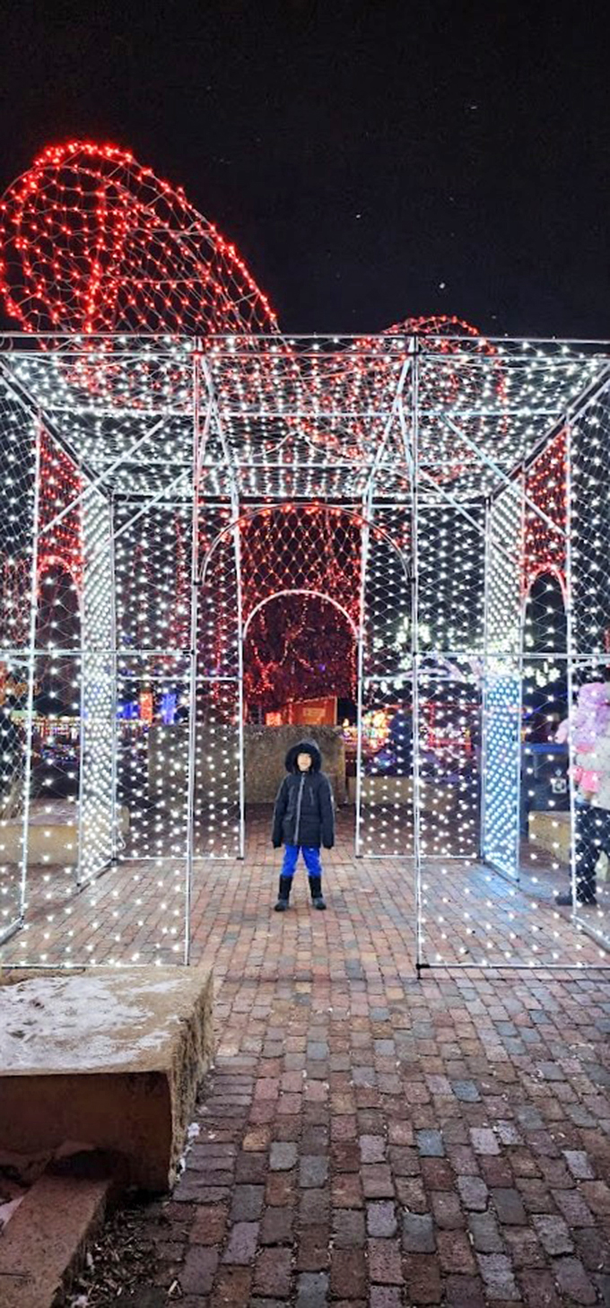 Step into a twinkling time machine! This luminous cube portal transports visitors to a magical realm where holiday cheer reigns supreme.
