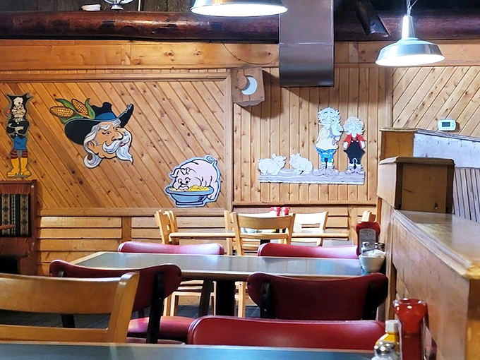 Knotty pine walls adorned with whimsical cartoon characters create the perfect backdrop for comfort food conversations and lakeside memories.