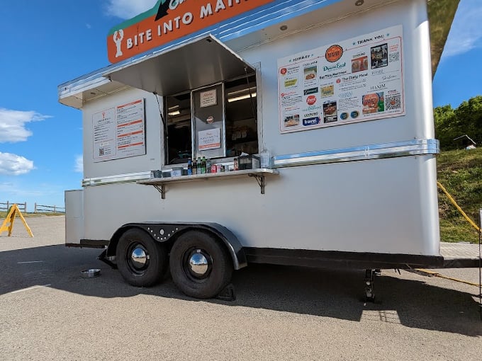 The American flag waves proudly above this coastal culinary outpost, where lobster dreams come true daily. Photo credit: Stephen Priest