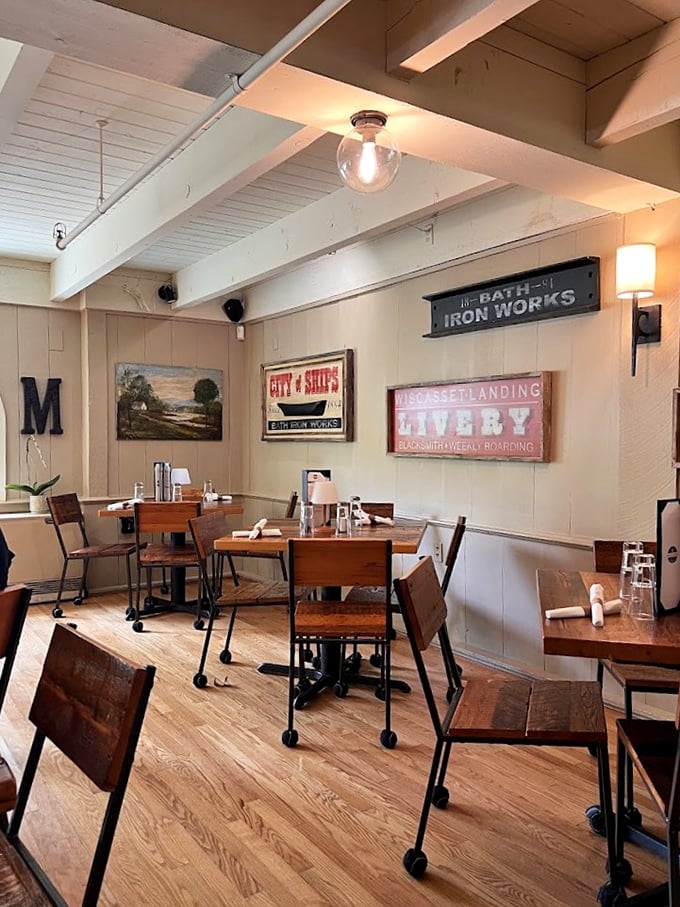 Vintage signs and warm wood tones create a cozy dining room that feels like stepping into Maine's maritime history.