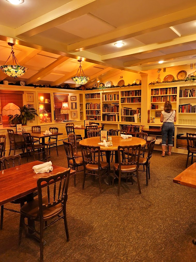 Books and bistro combine in this cozy dining room, where Tiffany-style lamps cast a golden glow over well-worn classics.