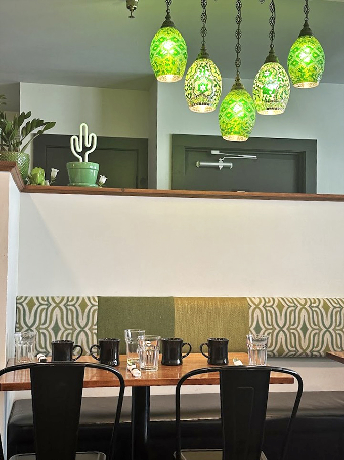 Emerald pendant lights and modern-meets-cozy decor create the perfect spot for your next breakfast adventure.