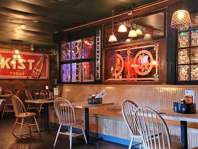 Windsor chairs and vintage signs create a cozy pub atmosphere where conversations flow as freely as the craft beer.
