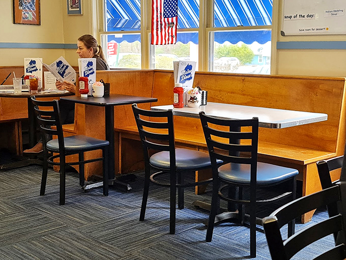Cozy wooden booths and warm sunlight streaming through windows create the perfect setting for comfort food conversations.