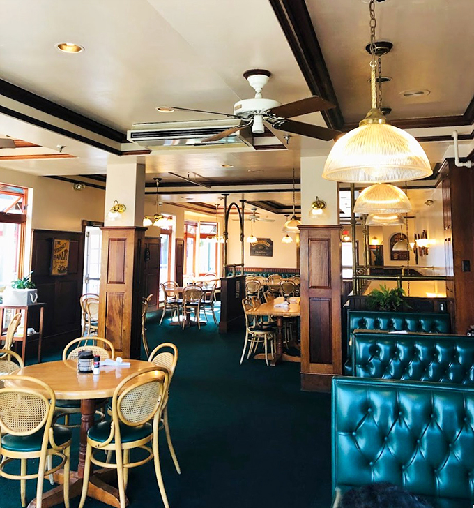 Tufted leather booths and warm wood paneling create the perfect maritime dining room, where comfort meets coastal elegance. 