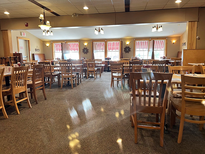 Nautical wheels and warm lighting create the perfect backdrop for seafood feasts, while wooden chairs await hungry visitors.