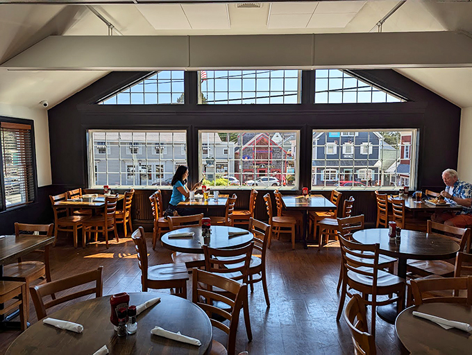 Sun streams through expansive windows, casting a warm glow across wooden tables where countless seafood stories have been shared.