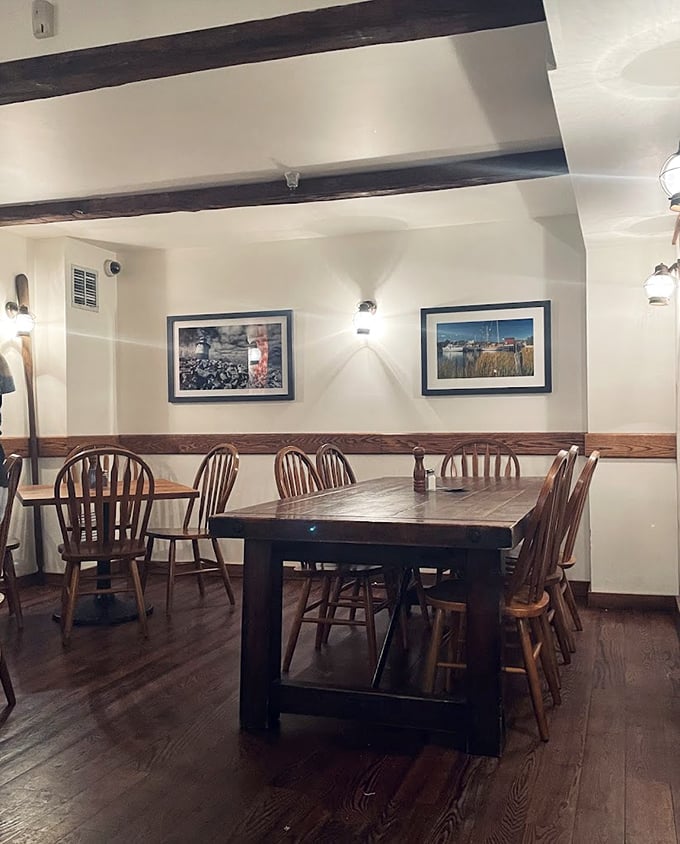 Windsor chairs and nautical artwork create a cozy dining room that feels like stepping into a seaside cottage, minus the sand in your shoes.