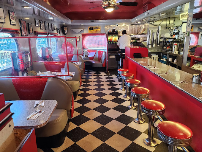 Red vinyl booths and chrome accents create the perfect backdrop for your nostalgic dining adventure. That checkerboard floor has seen countless happy feet. Photo credit: Jeremy Rasmussen