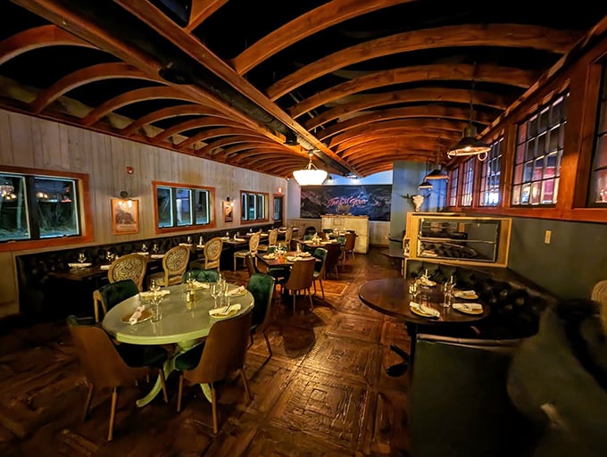 Exposed wooden beams arch overhead like nature's cathedral, while elegant lighting creates the perfect ambiance for memorable meals. Photo credit: Rich A