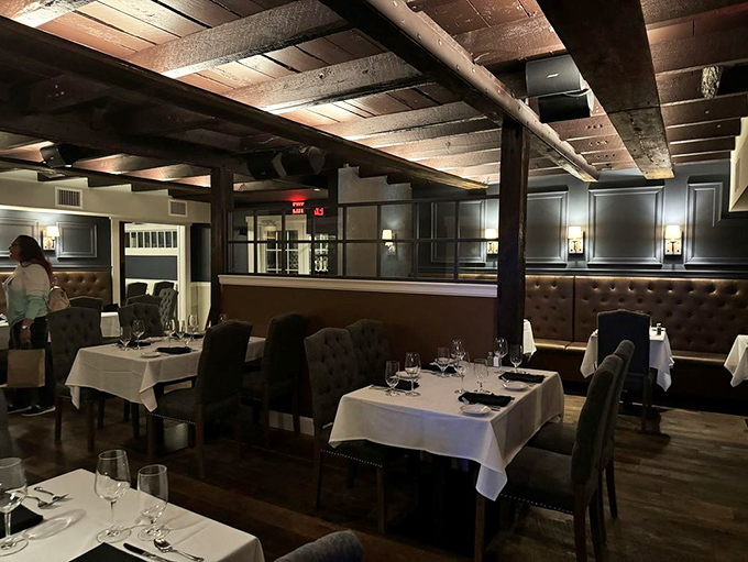 Dark wooden beams and plush seating create an atmosphere that's both rustic and refined - like a fancy dinner party in a cozy barn. Photo credit: Diane F.