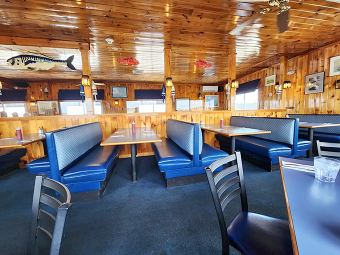 Knotty pine walls and navy blue booths create the perfect maritime mood, while decorative fish keep watch from above. Photo credit: Rafal G.