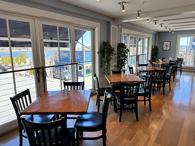 Honey-colored hardwood floors and walls of windows create the perfect stage for harbor views that'll make you forget your phone exists. Photo credit: Aaron Jandreau