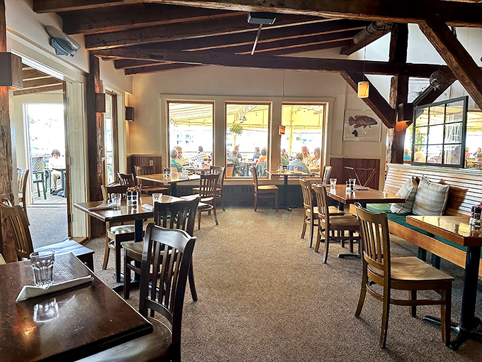 Exposed wooden beams and warm lighting create the perfect maritime mood, like stepping into a ship captain's cozy dining room. Photo credit: Sam Santiago