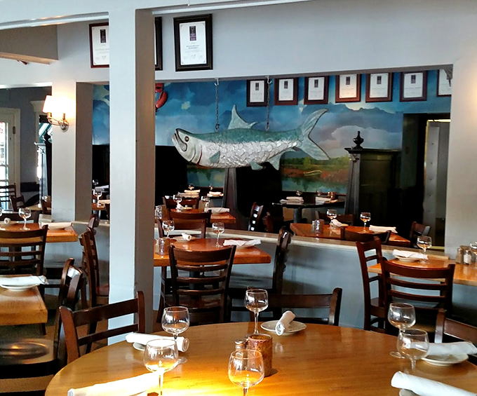 The restaurant's interior features a stunning fish mural that seems to swim right off the wall, watching over diners enjoying their meals. Photo credit: Kimberly Caldwell