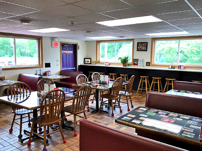 Classic New England charm meets cozy comfort in this dining room, where wooden chairs sport playful tennis ball feet.