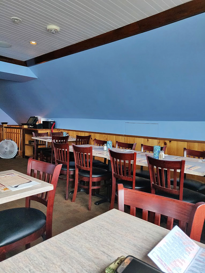 Classic New England charm meets maritime comfort in this cozy dining room. Wood paneling and warm lighting create the perfect seafood sanctuary.