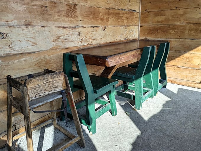 Simple green chairs and weathered wood walls tell stories of countless seafood feasts shared by locals and travelers alike.