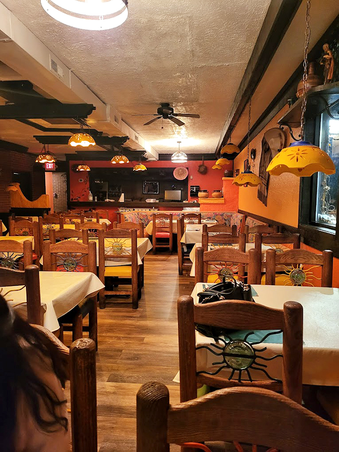 Wooden chairs adorned with cheerful sun motifs and warm pendant lighting create the perfect backdrop for your Mexican feast.