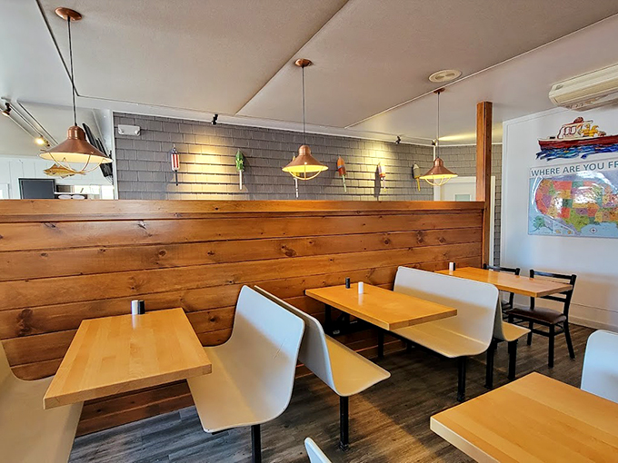 Modern meets maritime in this cozy dining room, where wooden walls and copper pendant lights create the perfect backdrop for seafood feasts.