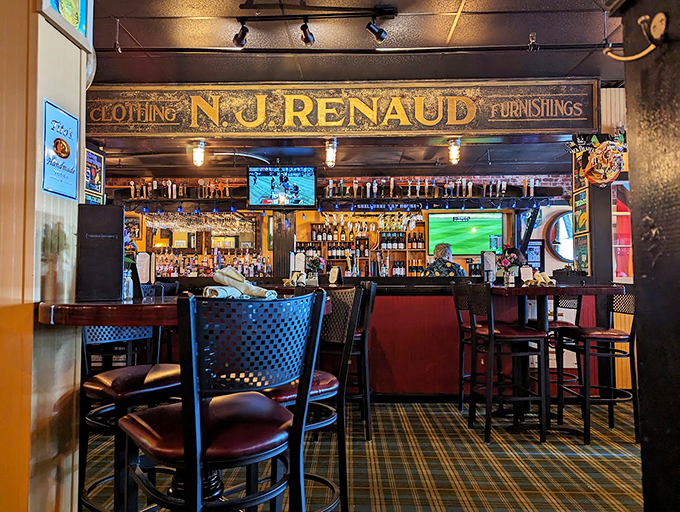 The vintage N.J. Renaud sign watches over modern revelry, proving great food and history make perfect drinking buddies.