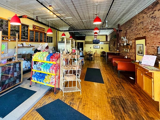 Exposed brick walls, warm wooden floors, and cherry-red pendant lights create the perfect backdrop for your sandwich adventure.