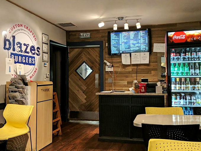 Warm wood paneling and cheerful yellow chairs create a cozy vibe that feels like your favorite aunt's kitchen, only with better burgers.