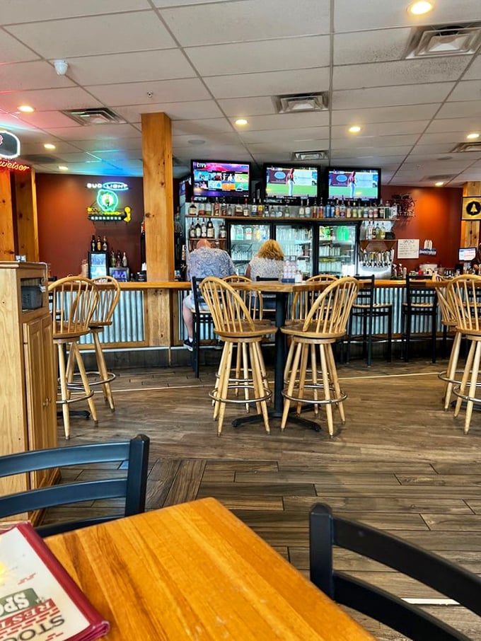 Windsor chairs line the rustic bar, where sports fans gather under the warm glow of multiple screens. Pure pub perfection!