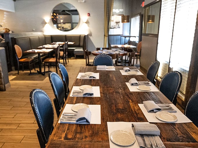 Rich wooden tables and navy blue chairs create an atmosphere that's both sophisticated and cozy - like a perfectly tailored suit.
