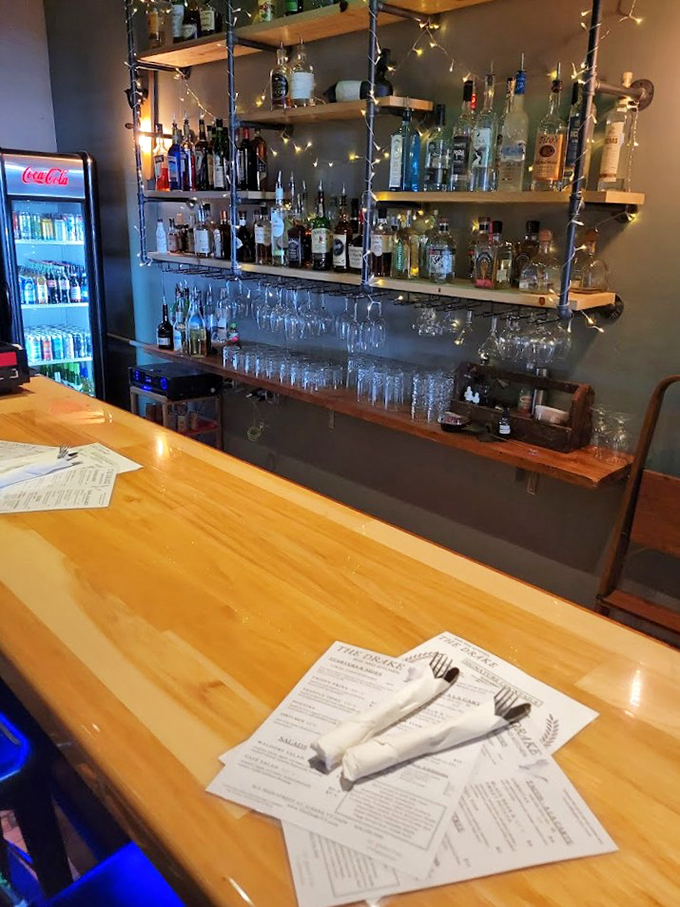 The bar's wooden shelves and twinkling lights create the perfect backdrop for evening adventures in craft cocktails and conversation.